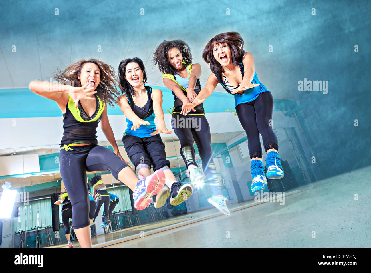 group of women in sport dress jumping at fitness dance excercise or ...