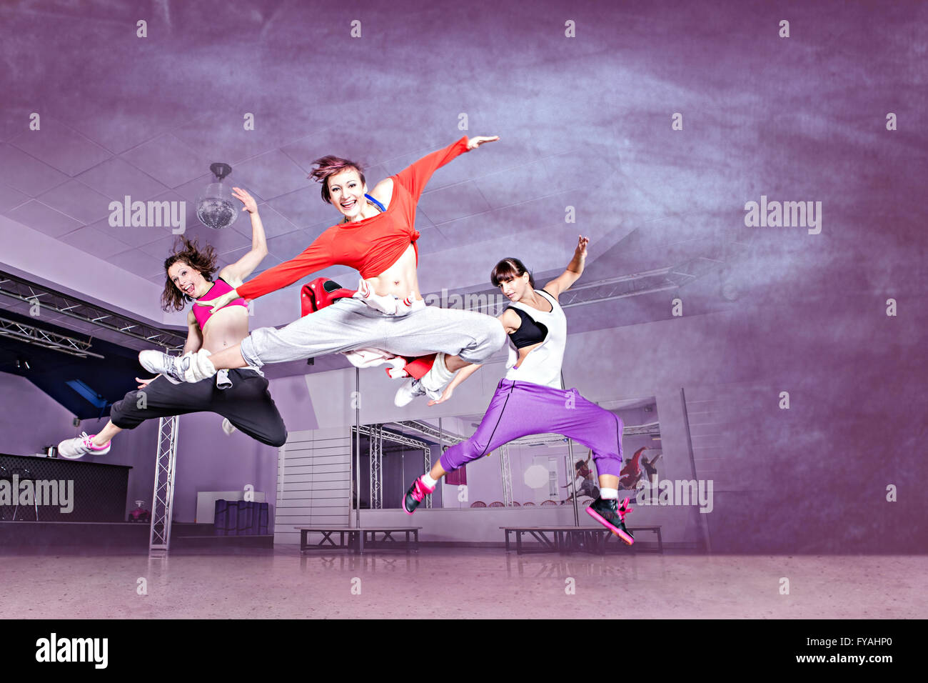 group of women in sport dress jumping at fitness dance excercise or ...