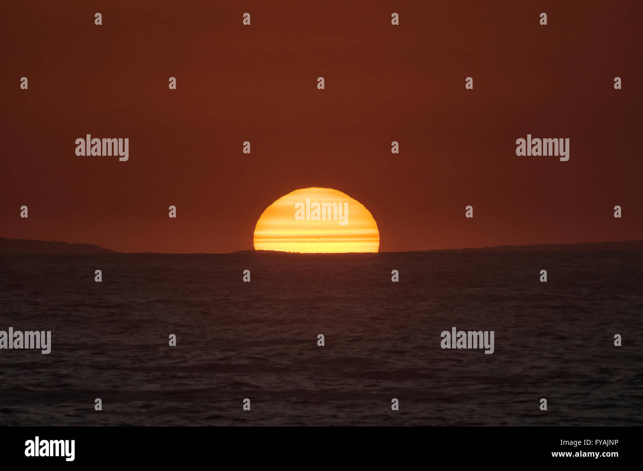 A fiery sunset over the Indian ocean on the Eastern Cape coast of South ...