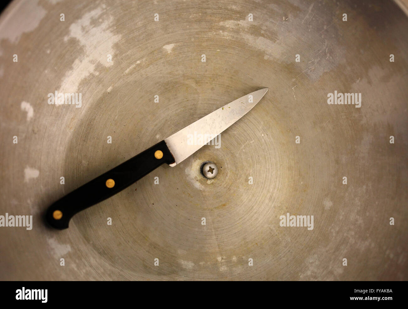 Knife inside the lid of a wok Stock Photo - Alamy