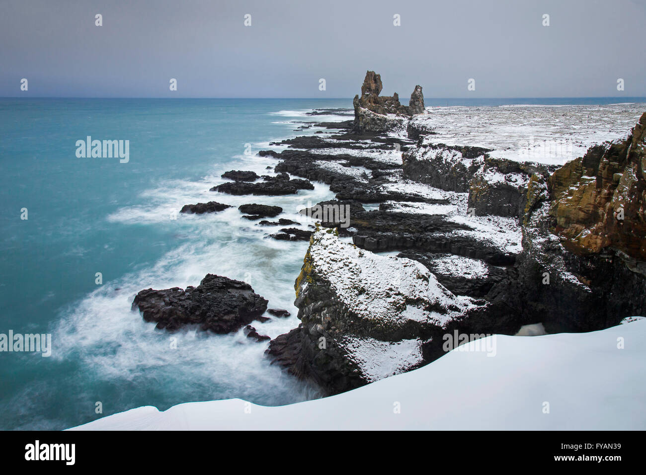 Londrangar, pair of volcanic plugs of basalt in the snow in winter ...