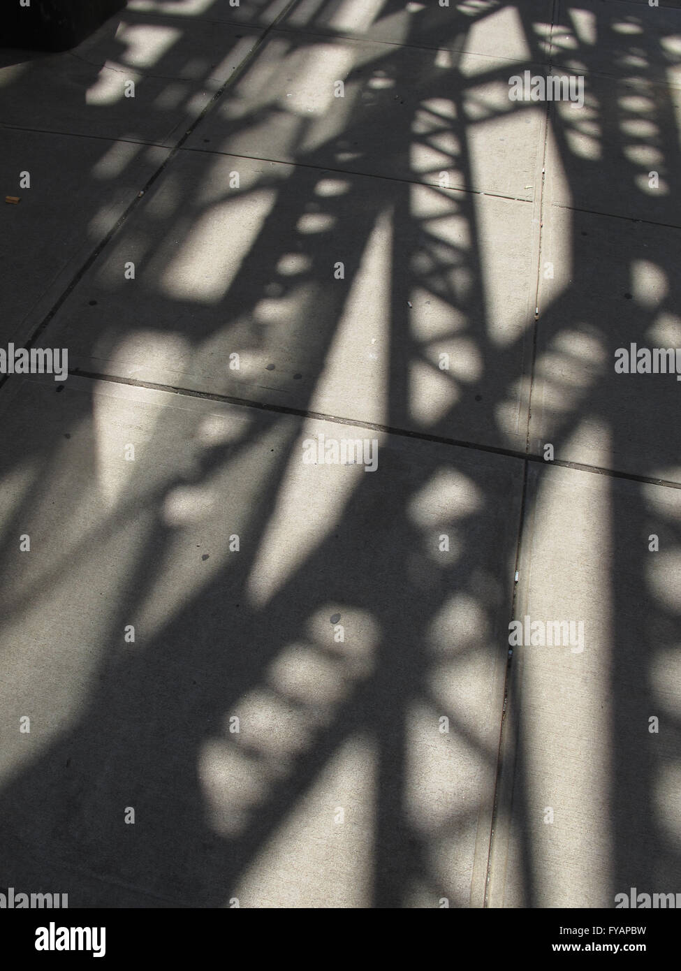 steel structure of elevated subway casts shadow on 23rd Street sidewalk ...