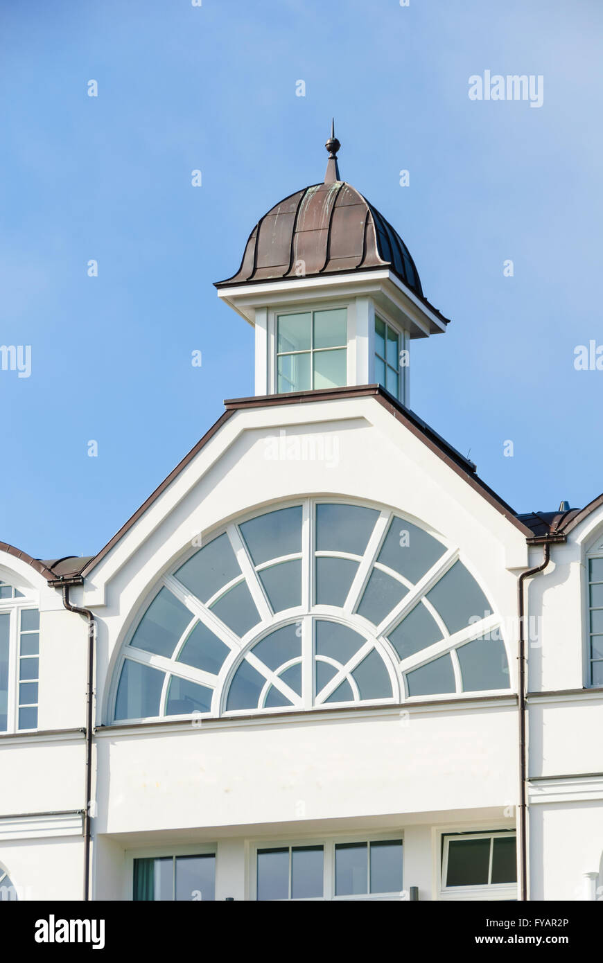 Building facade in a modernized resort architecture with arched windows ...