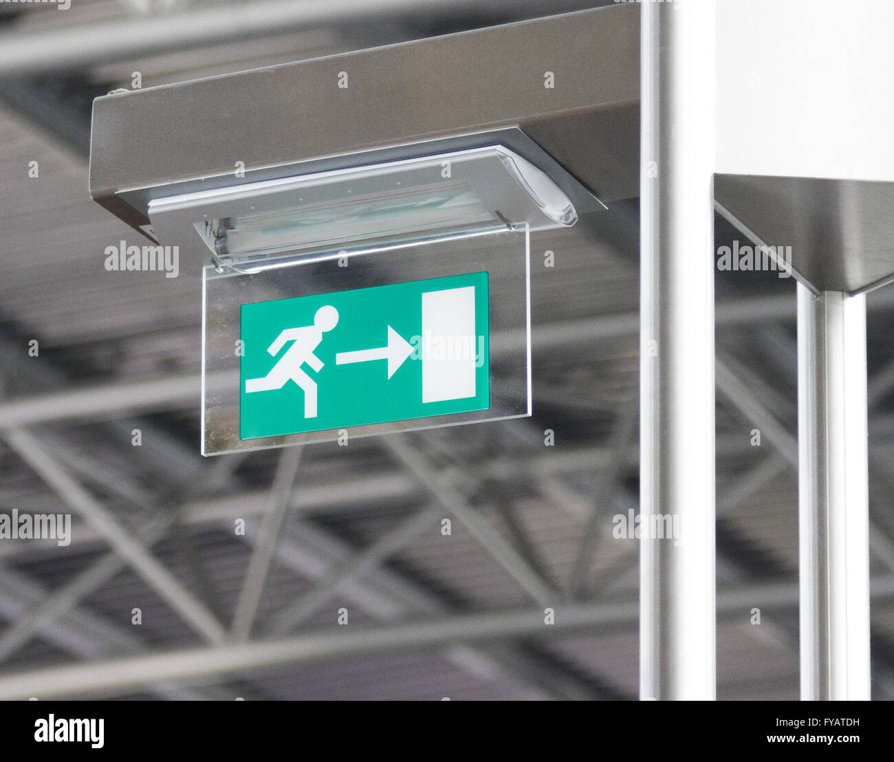 Emergency exit sign, green color Stock Photo - Alamy