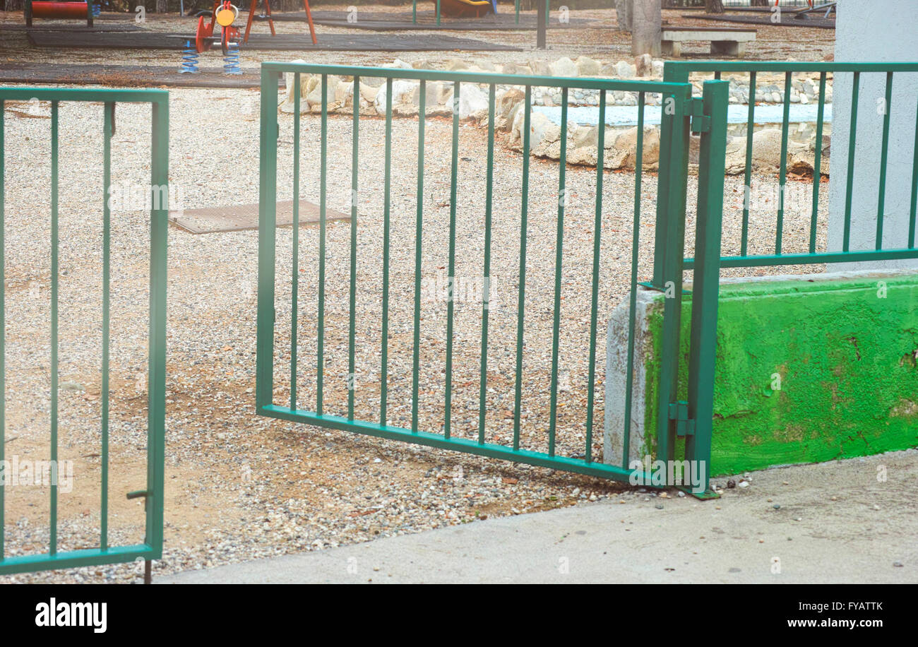Open gate to playground. Focus is on the ground Stock Photo - Alamy