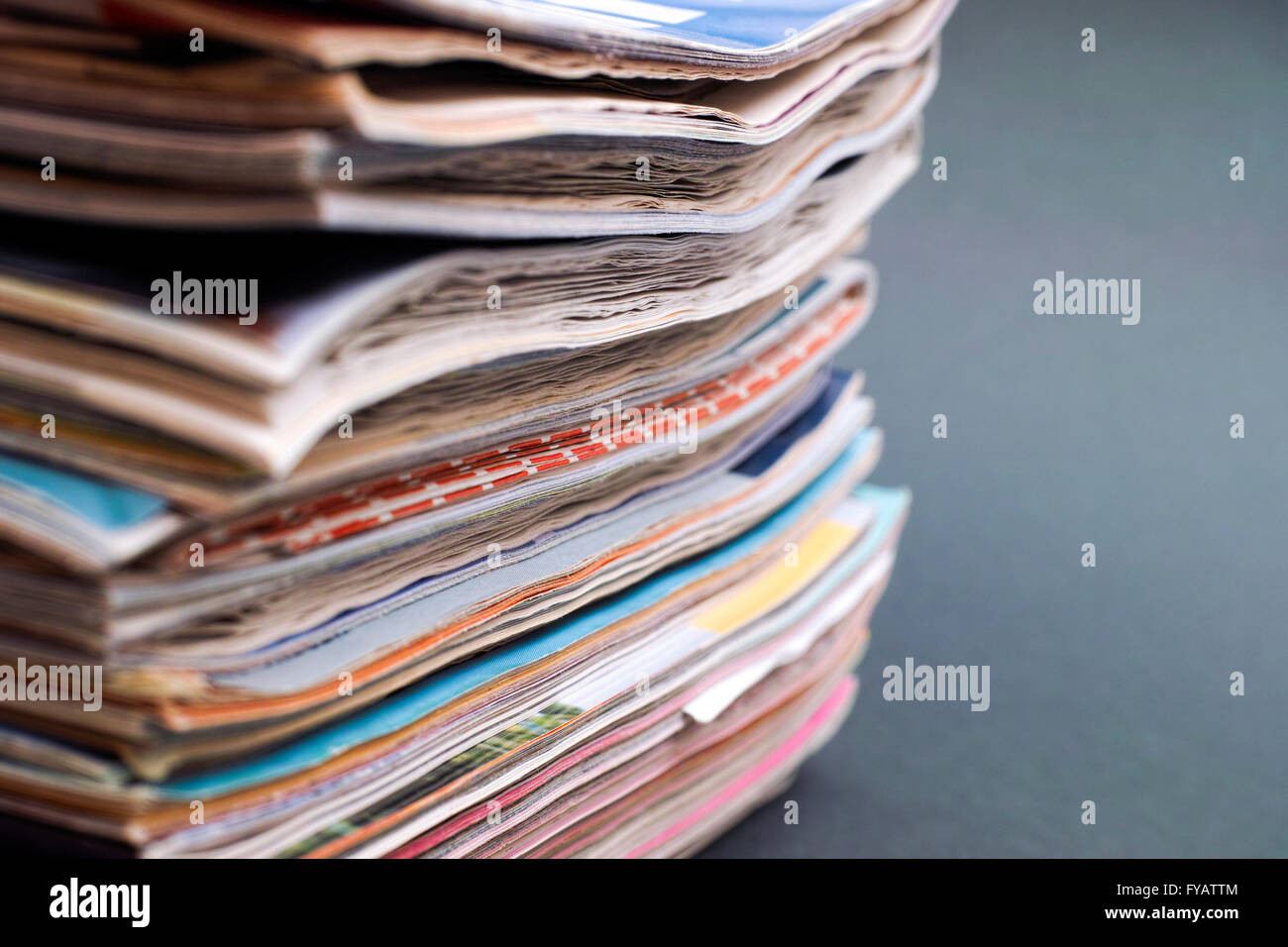 Stack of magazines on dark green background Stock Photo - Alamy