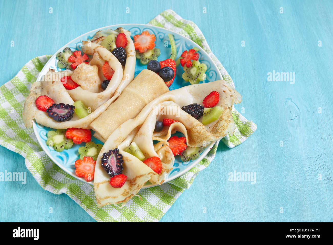 Funny butterfly shaped crepes with berries Stock Photo - Alamy