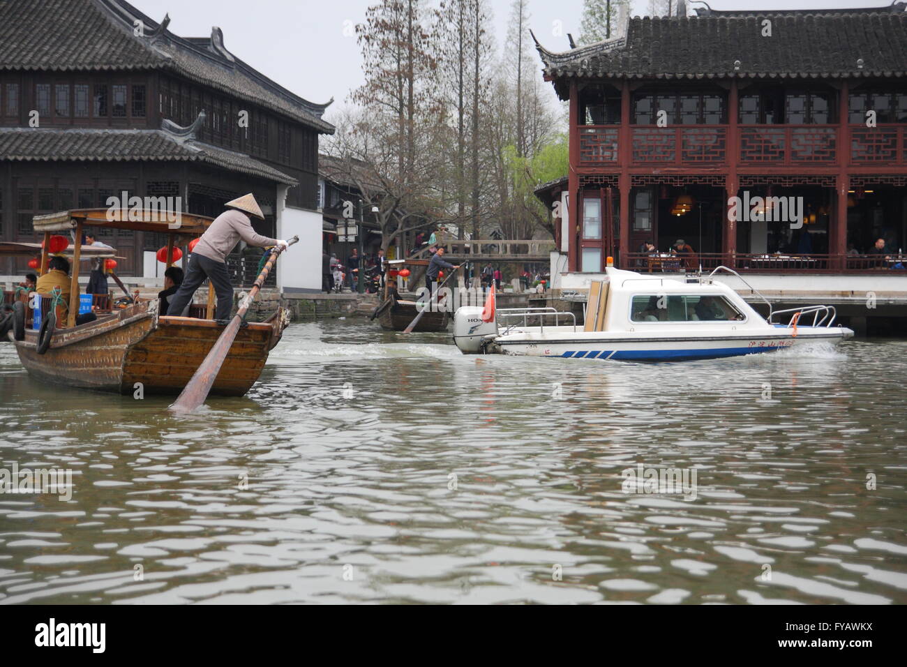 A photograph contrasting modern boating and traditional Chinese boating ...