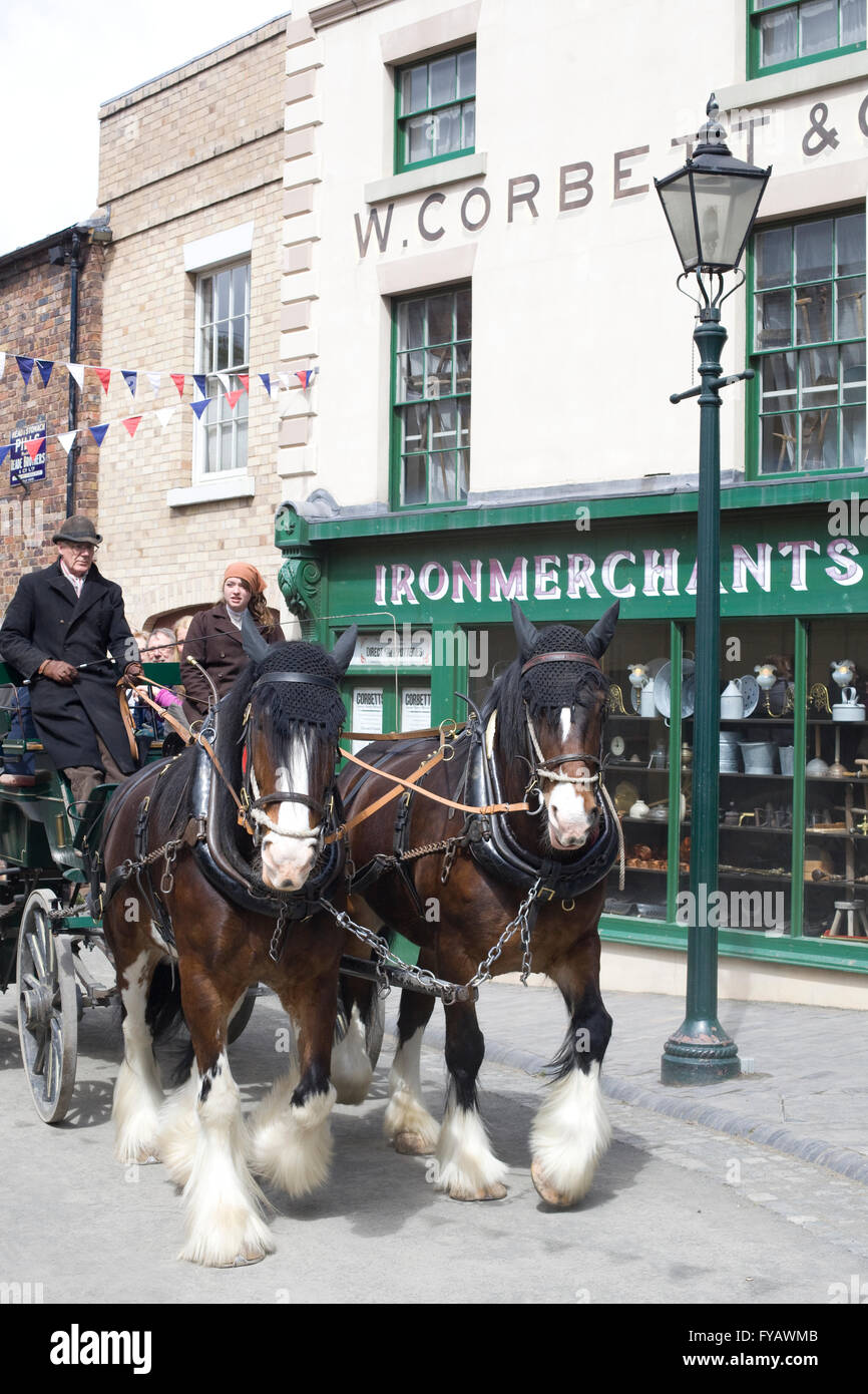 Horse and carriage passing the iron merchant's in the Victorian village ...