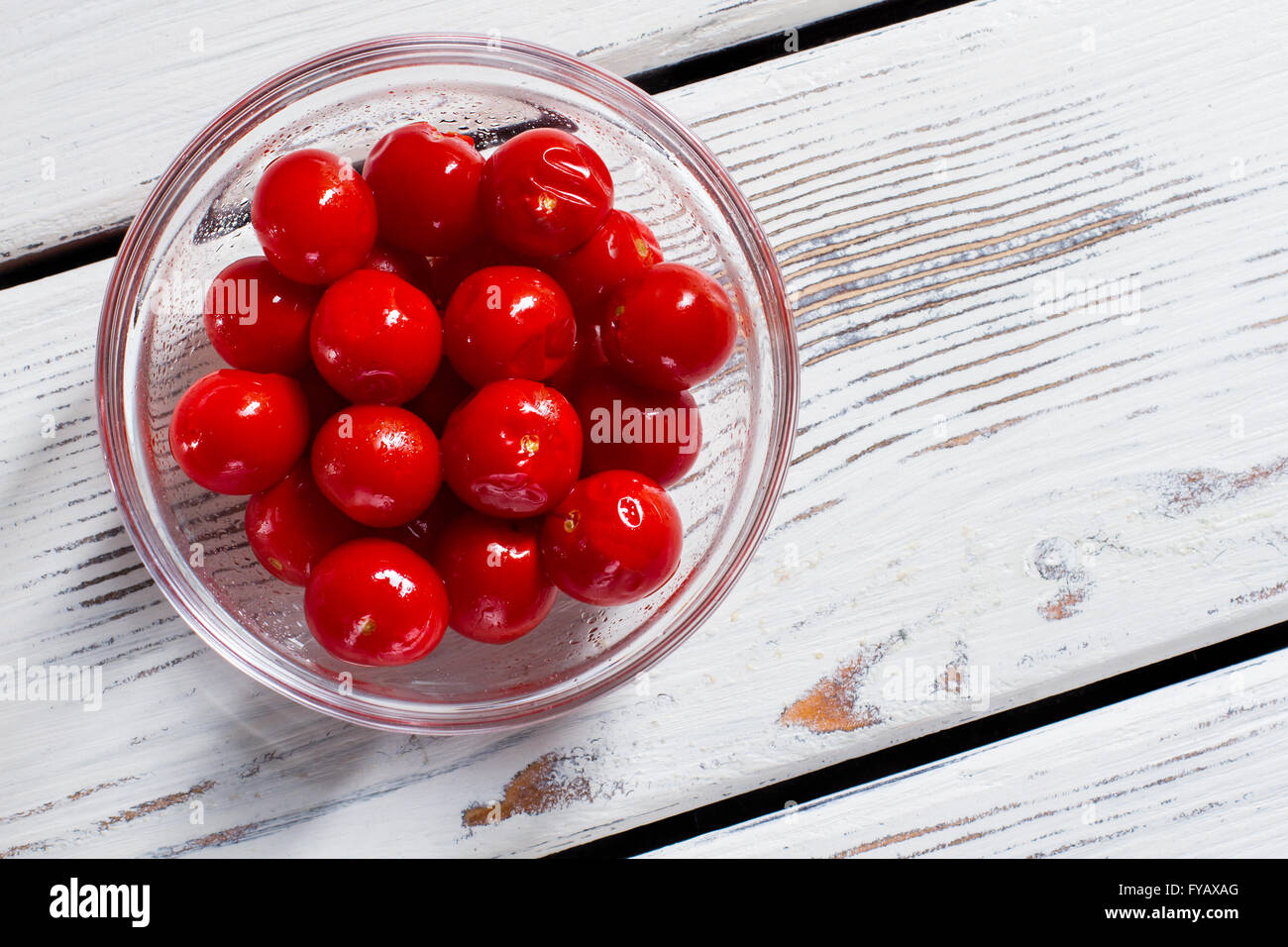 Red tomatoes in glass bowl Stock Photo - Alamy