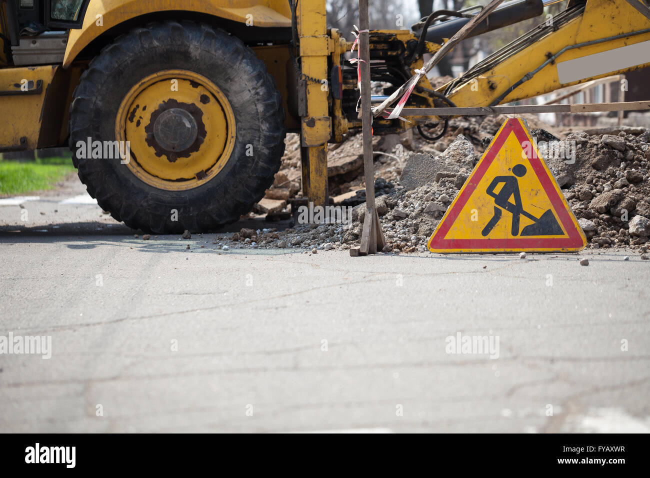 This road is under construction and closed. Yellow safety sign warns ...
