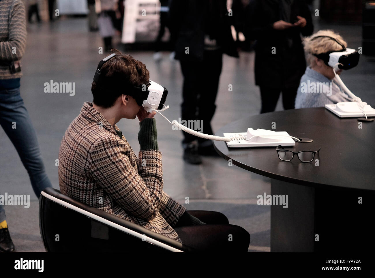 A visitor watches VR content through virtual reality goggles at the ...