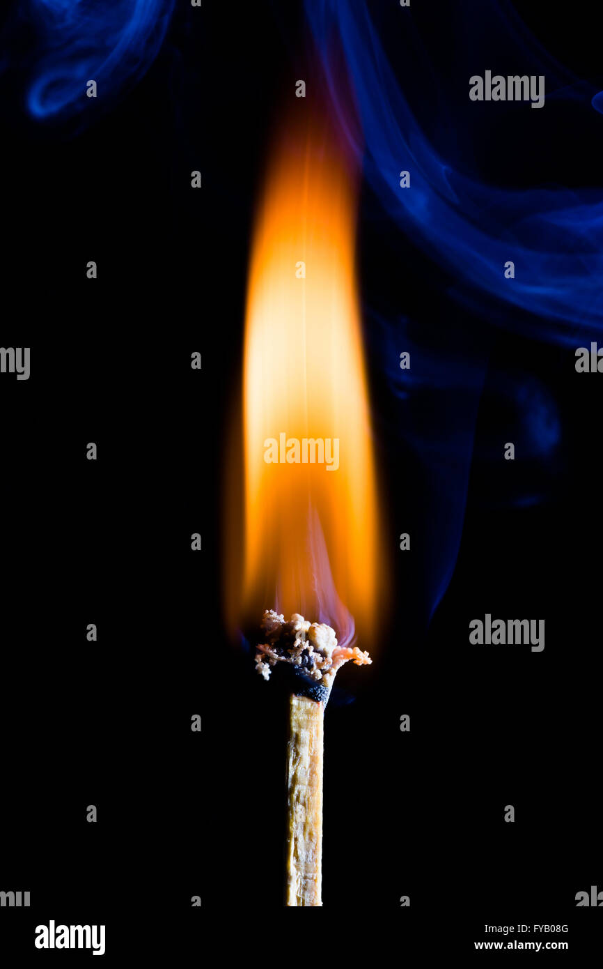 Head matches being lit on a black background Stock Photo - Alamy