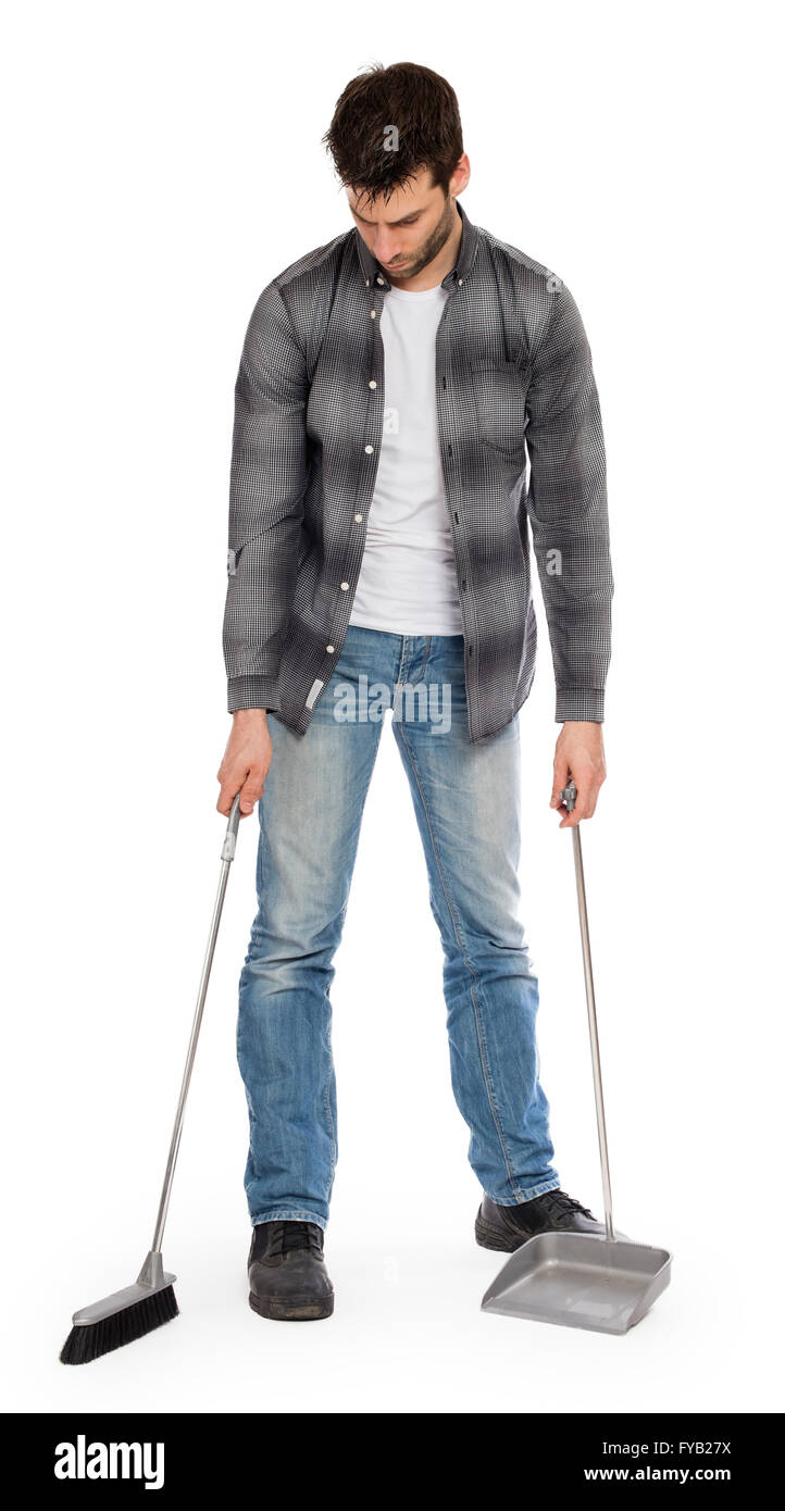 Full isolated studio picture from a young worker with a broom Stock ...