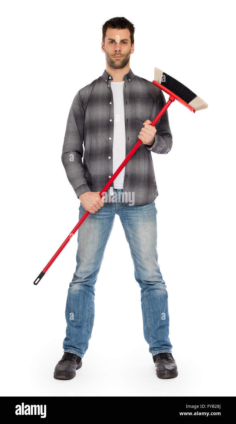 Full isolated studio picture from a young worker with a broom Stock ...