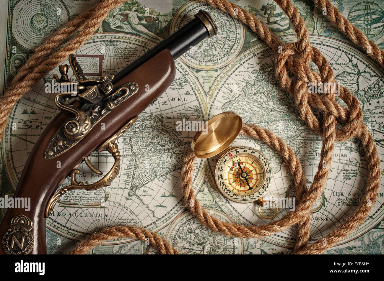 Ancient musket, compass and rope lying on the old map Stock Photo - Alamy