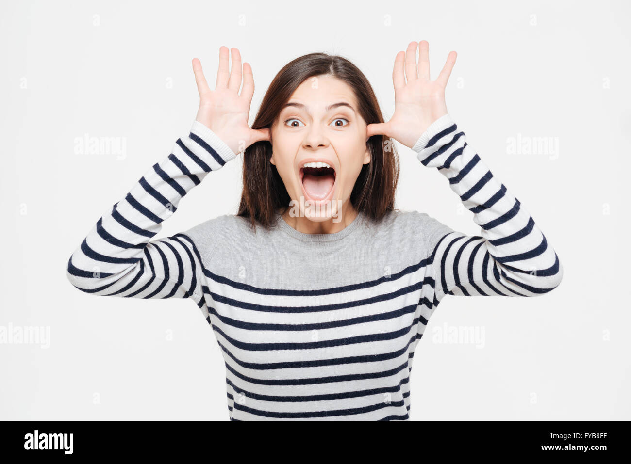 Woman screaming and making funny face isolated on a white background ...