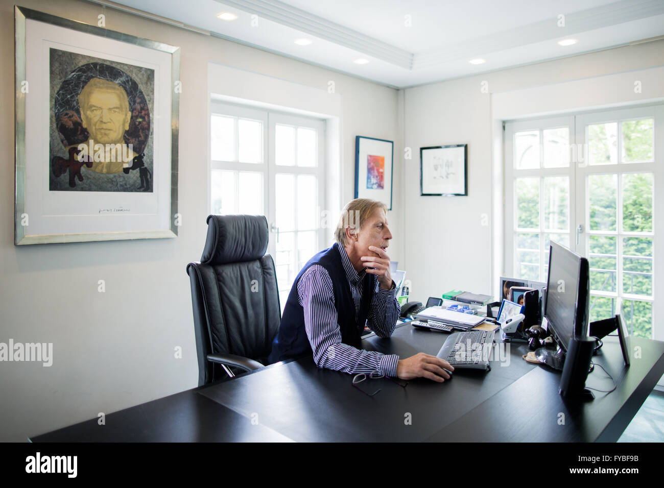 dpa-Exclusive - Soccer coach Christoph Daum works on his computer as he ...