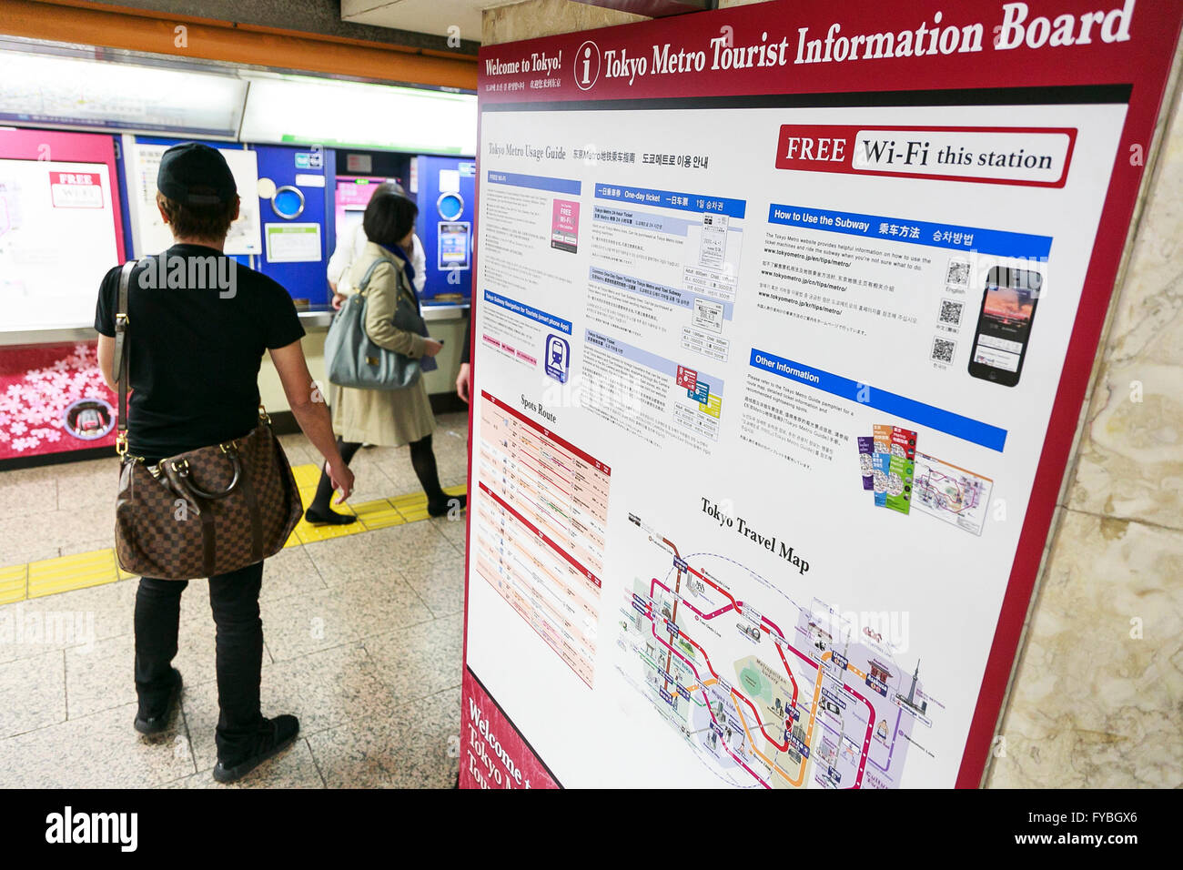 A foreign tourist stands next to a Tokyo Metro Tourist Information ...