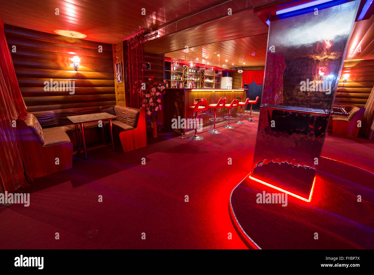 Interior of a restaurant with bar in red light Stock Photo - Alamy