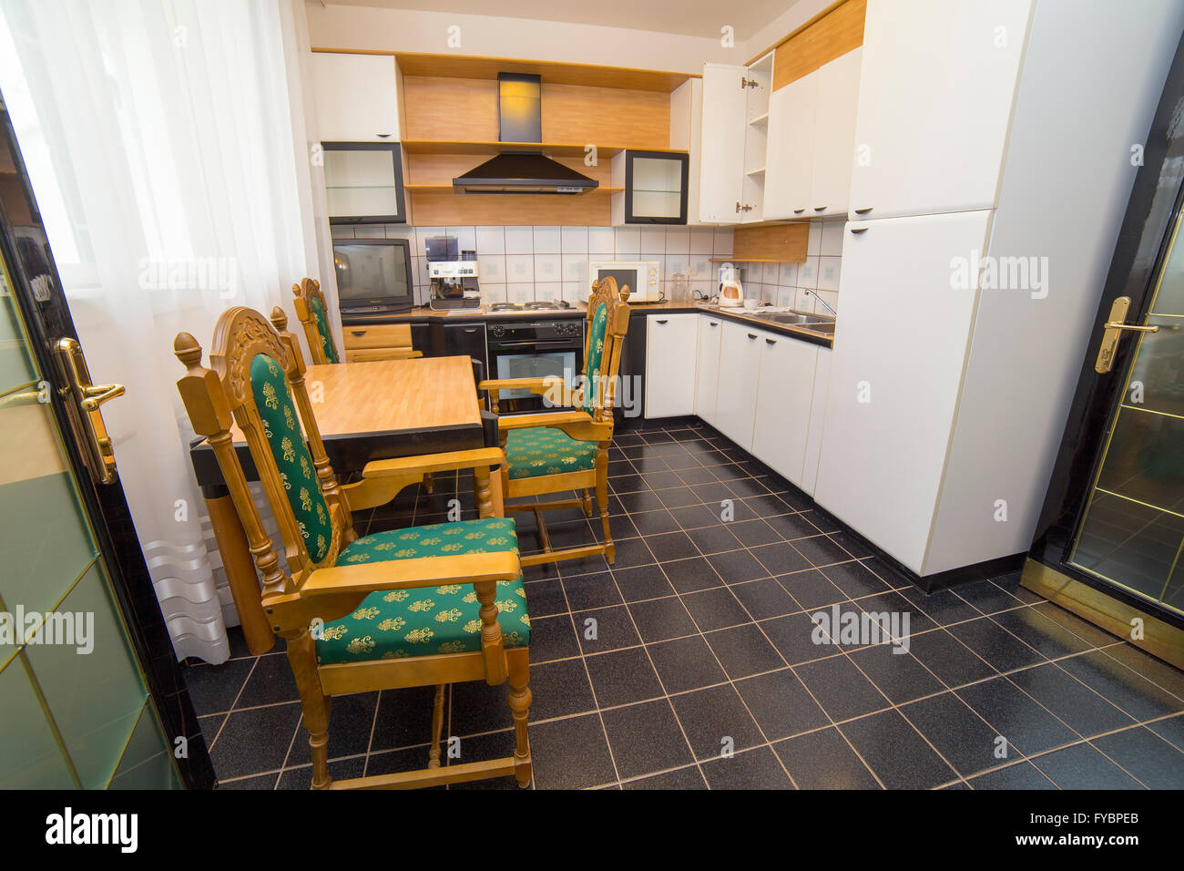 Nice kitchen interior with wooden chairs Stock Photo - Alamy