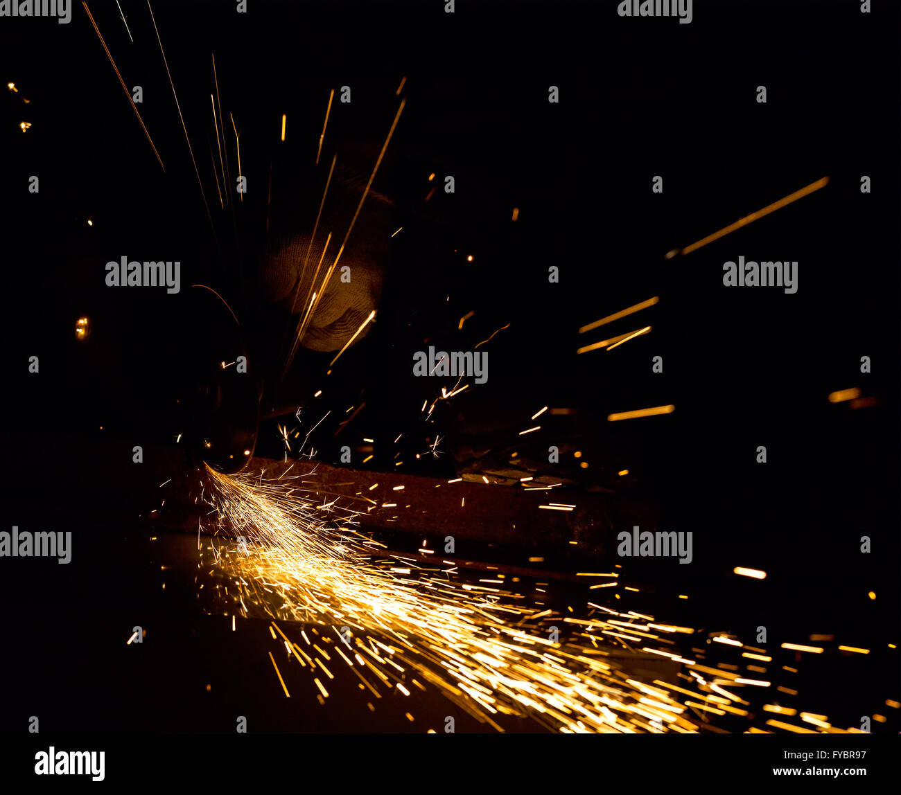 Sparks in the dark from a working grinding machine Stock Photo - Alamy