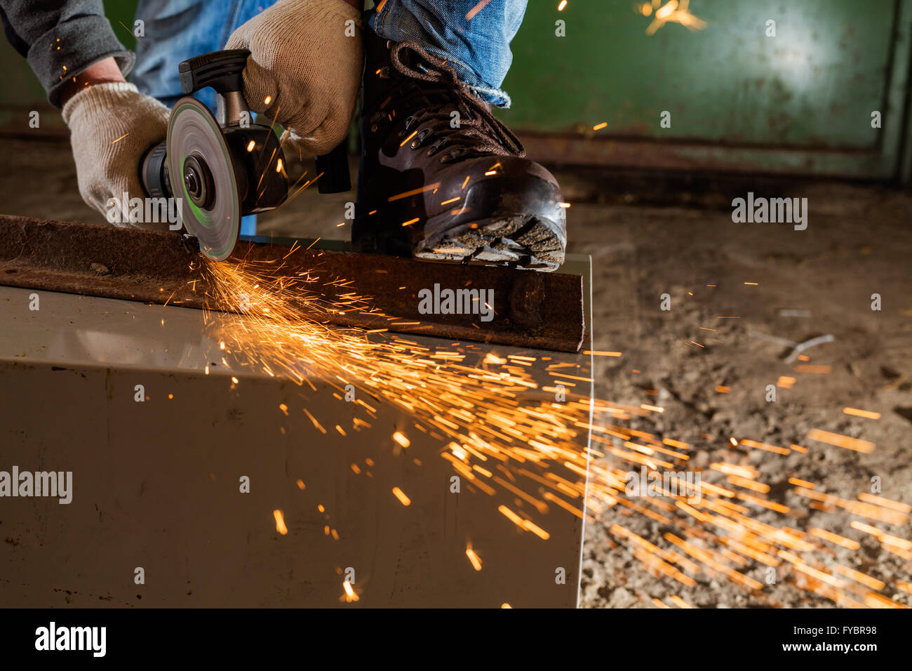 Worker working of a grinding machine with a lot of sparks Stock Photo ...