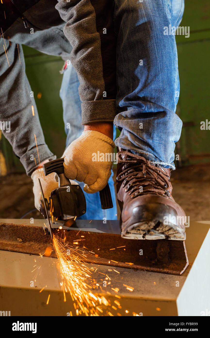 Worker working of a grinding machine with a lot of sparks Stock Photo ...