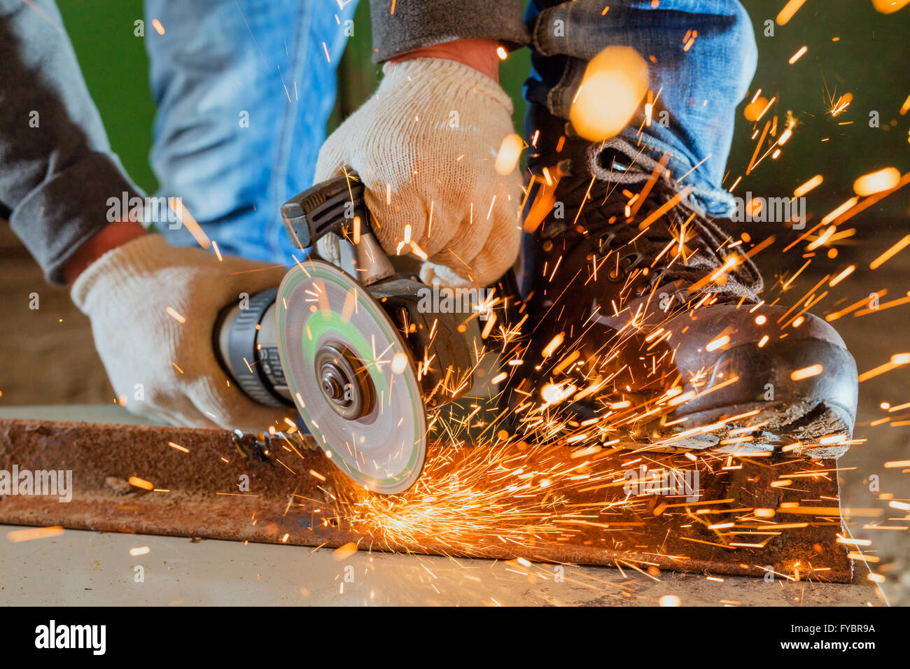 Worker working of a grinding machine with a lot of sparks Stock Photo ...