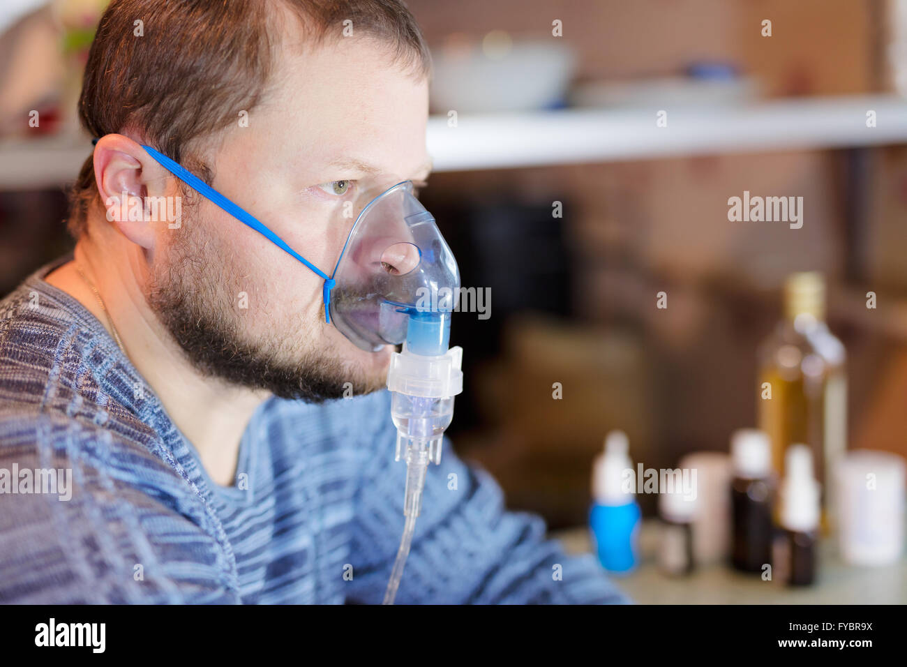Man sitting with nebulizer mask close up view Stock Photo - Alamy
