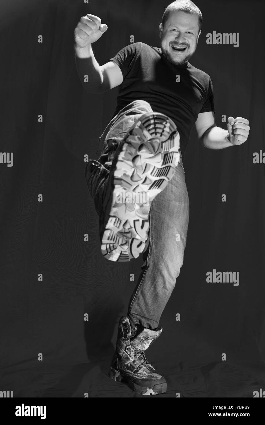 Emotional portrait of agressive bully fighting on black background ...