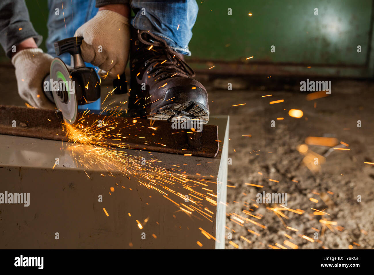 Worker working of a grinding machine with a lot of sparks Stock Photo ...