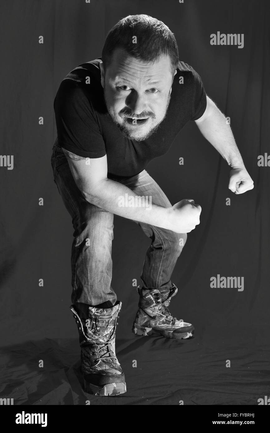 Emotional portrait of agressive bully fighting on black background ...