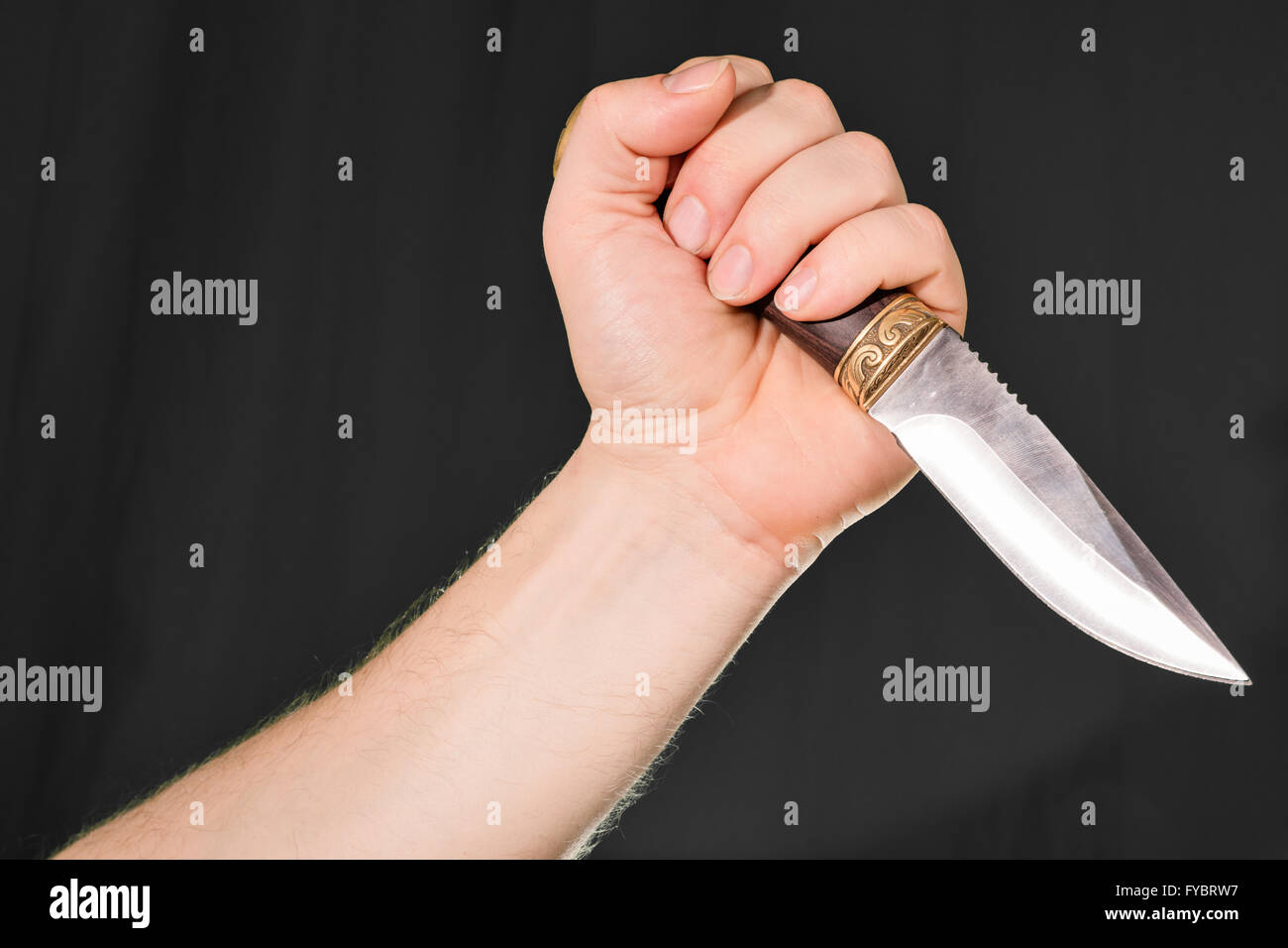 Man's hand holding knife close up view on black background Stock Photo ...