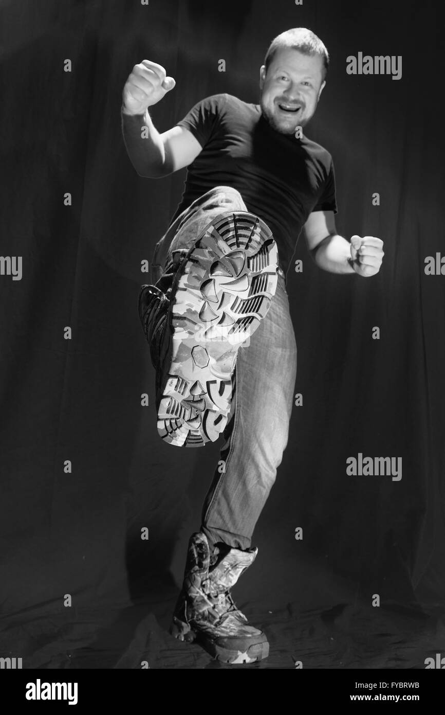 Emotional portrait of agressive bully fighting on black background ...