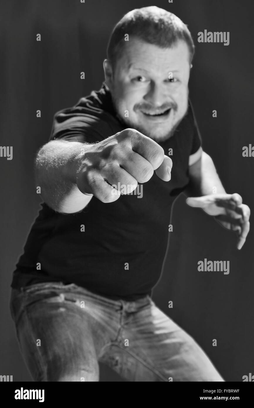 Emotional portrait of agressive bully fighting on black background ...