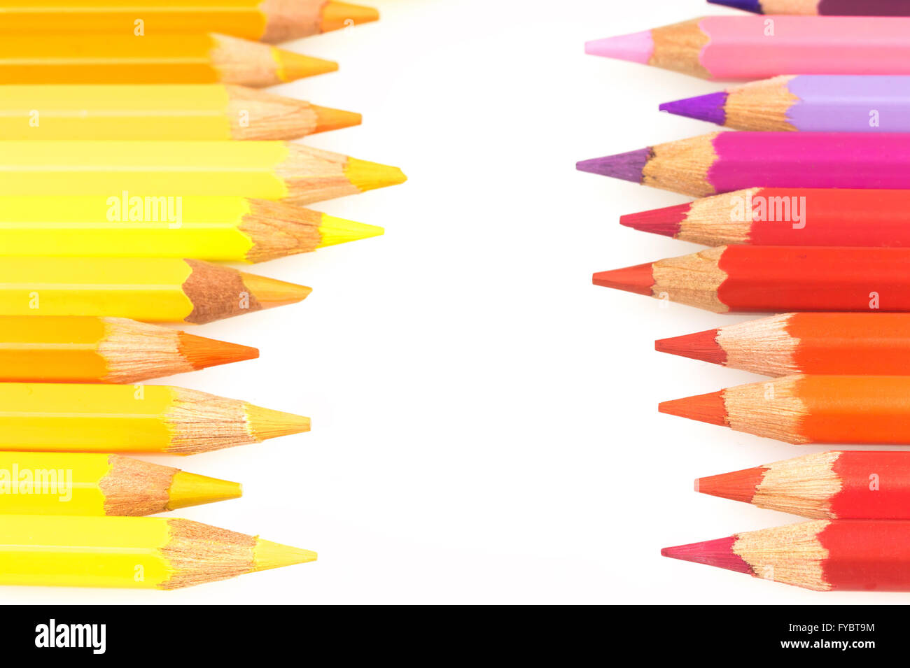 Crayons of different shades of red and yellow color with copy space are ...