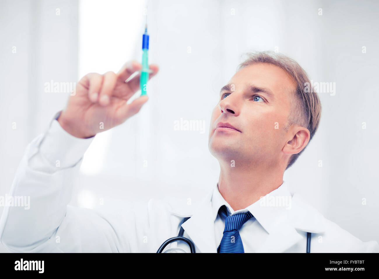 male doctor holding syringe with injection Stock Photo - Alamy