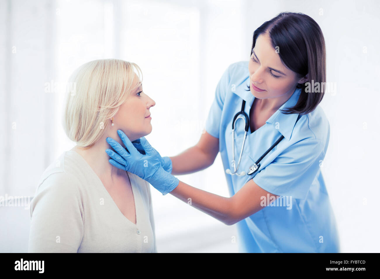 plastic surgeon or doctor with patient Stock Photo - Alamy