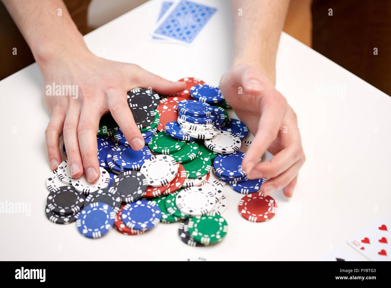 hands with casino chips making bet or taking win Stock Photo - Alamy