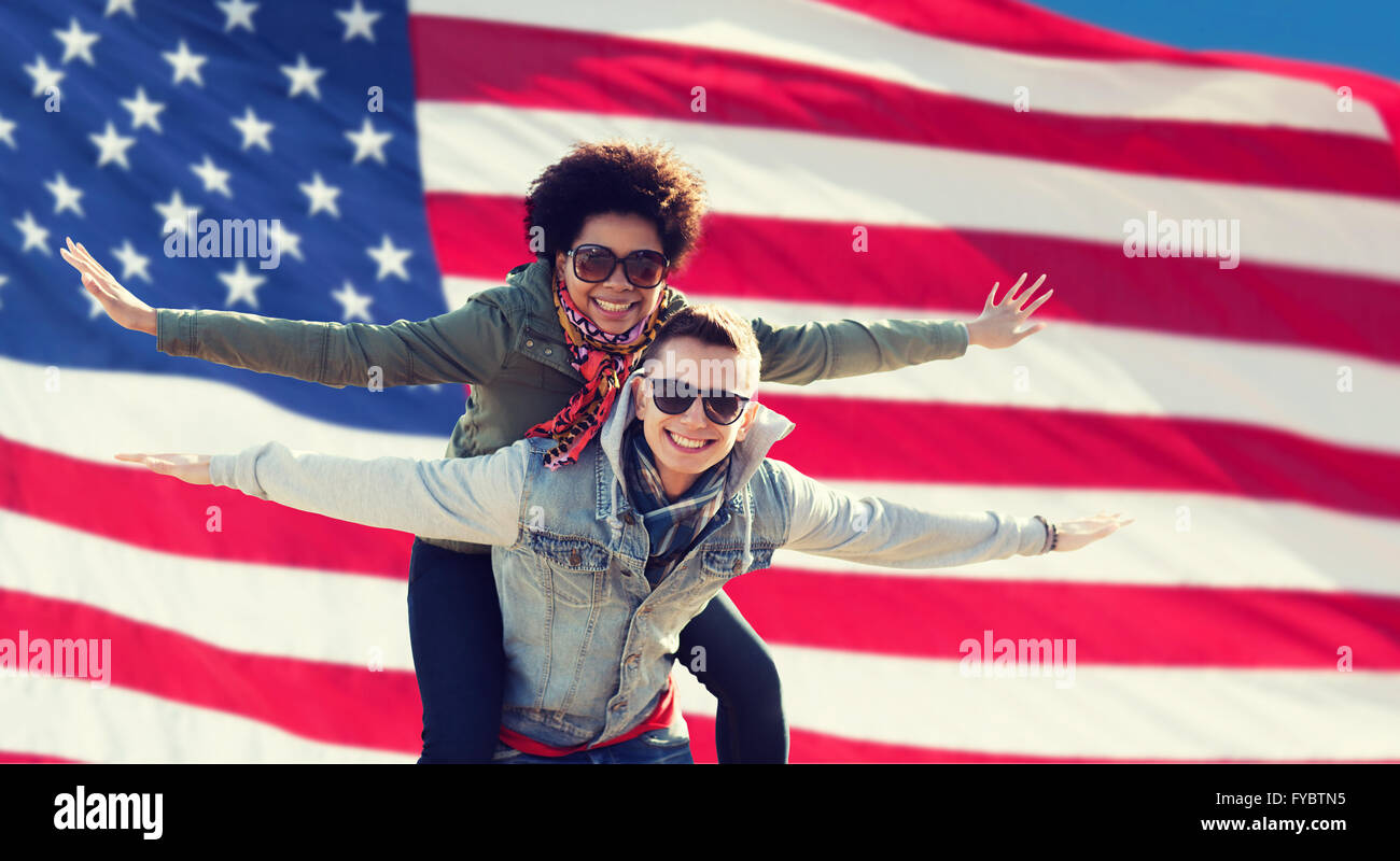 happy multiracial couple over american flag Stock Photo - Alamy