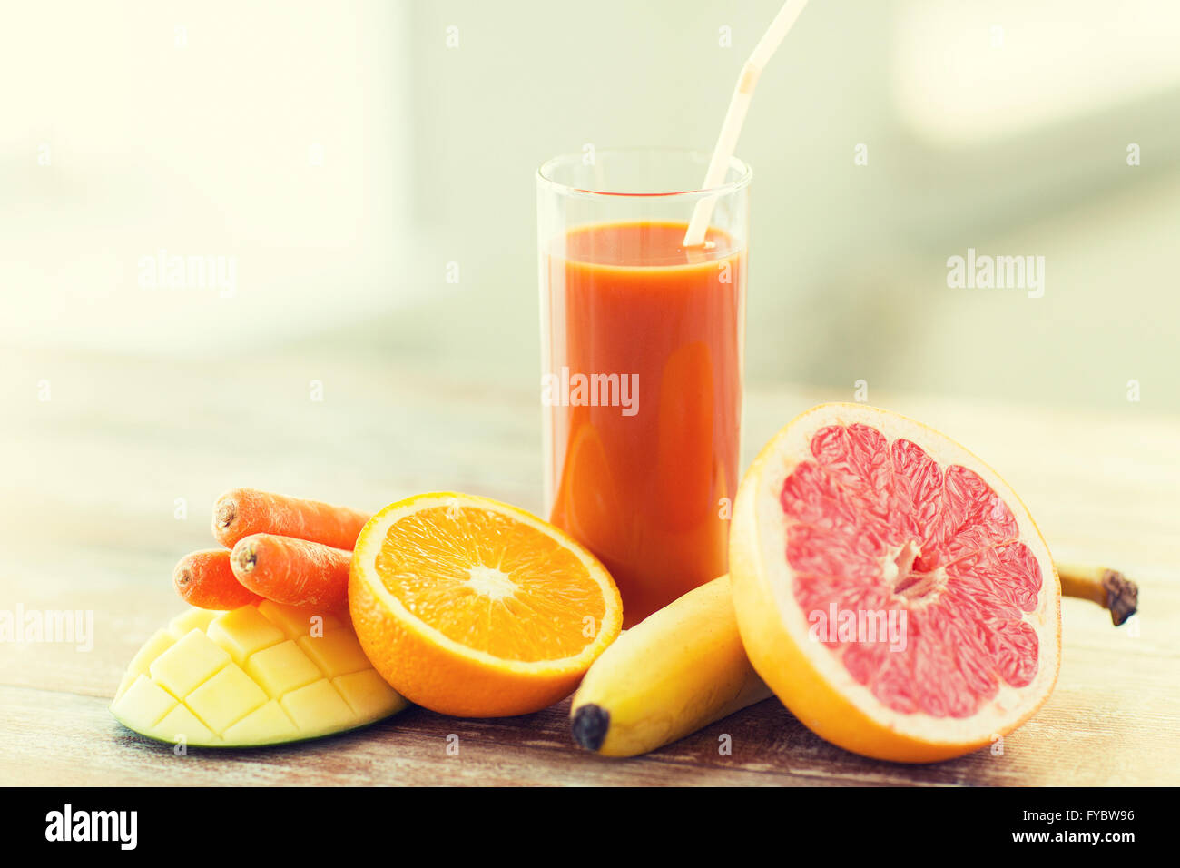 close up of fresh juice glass and fruits on table Stock Photo - Alamy