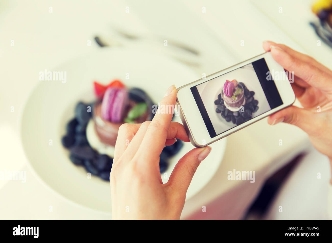 close up of woman picturing food by smartphone Stock Photo - Alamy