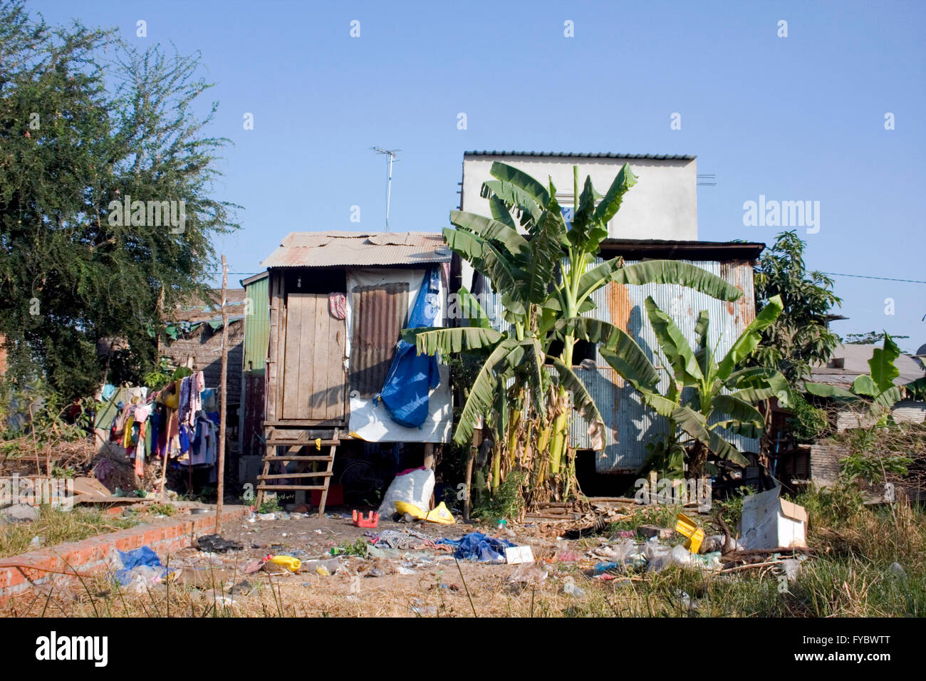 A ramshackle wood home is part of the urban landscape in Kampong Cham ...