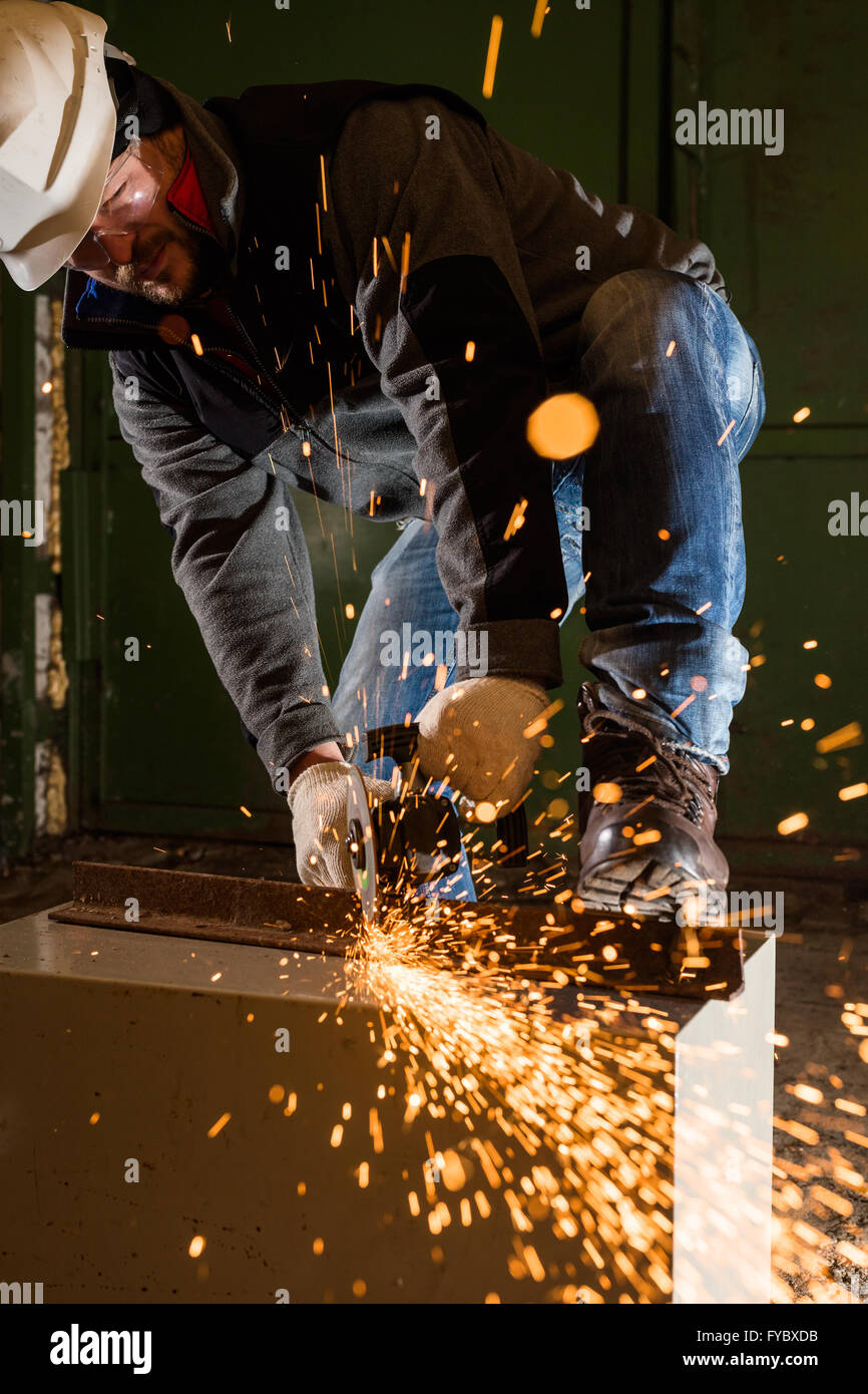 Worker working of a grinding machine with a lot of sparks Stock Photo ...