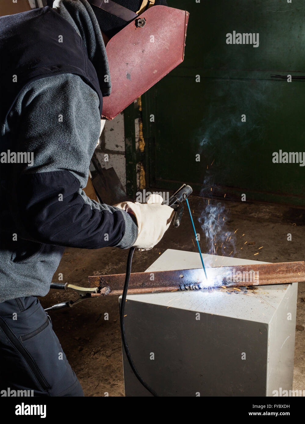 Welder working in a factory welding the metal metalwork Stock Photo - Alamy