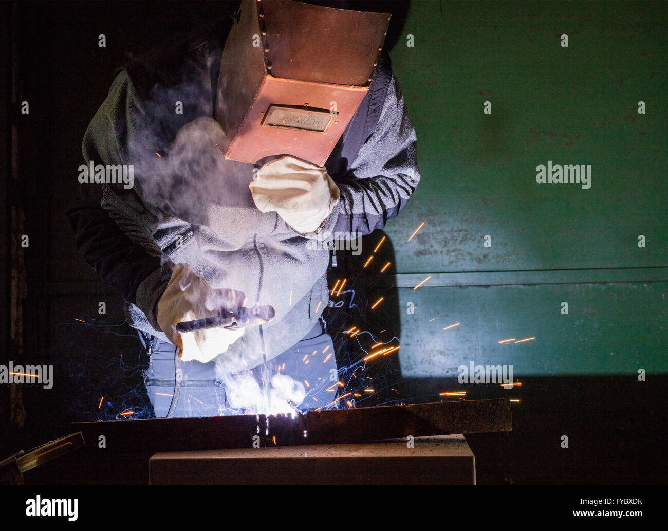 Welder working in a factory welding the metal metalwork Stock Photo - Alamy