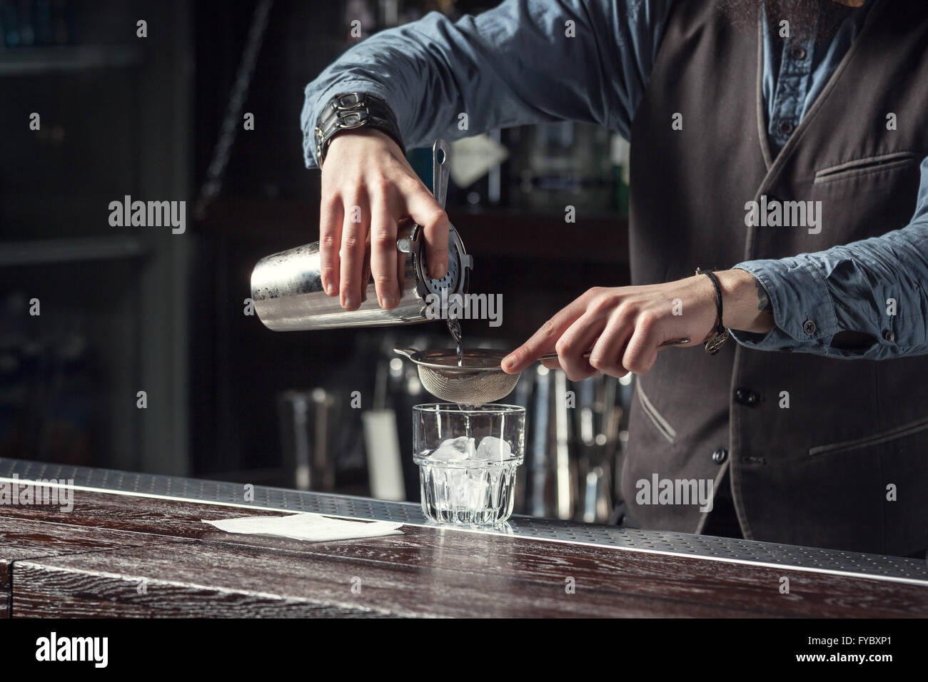 Barman makes cocktails with a shaker Stock Photo - Alamy