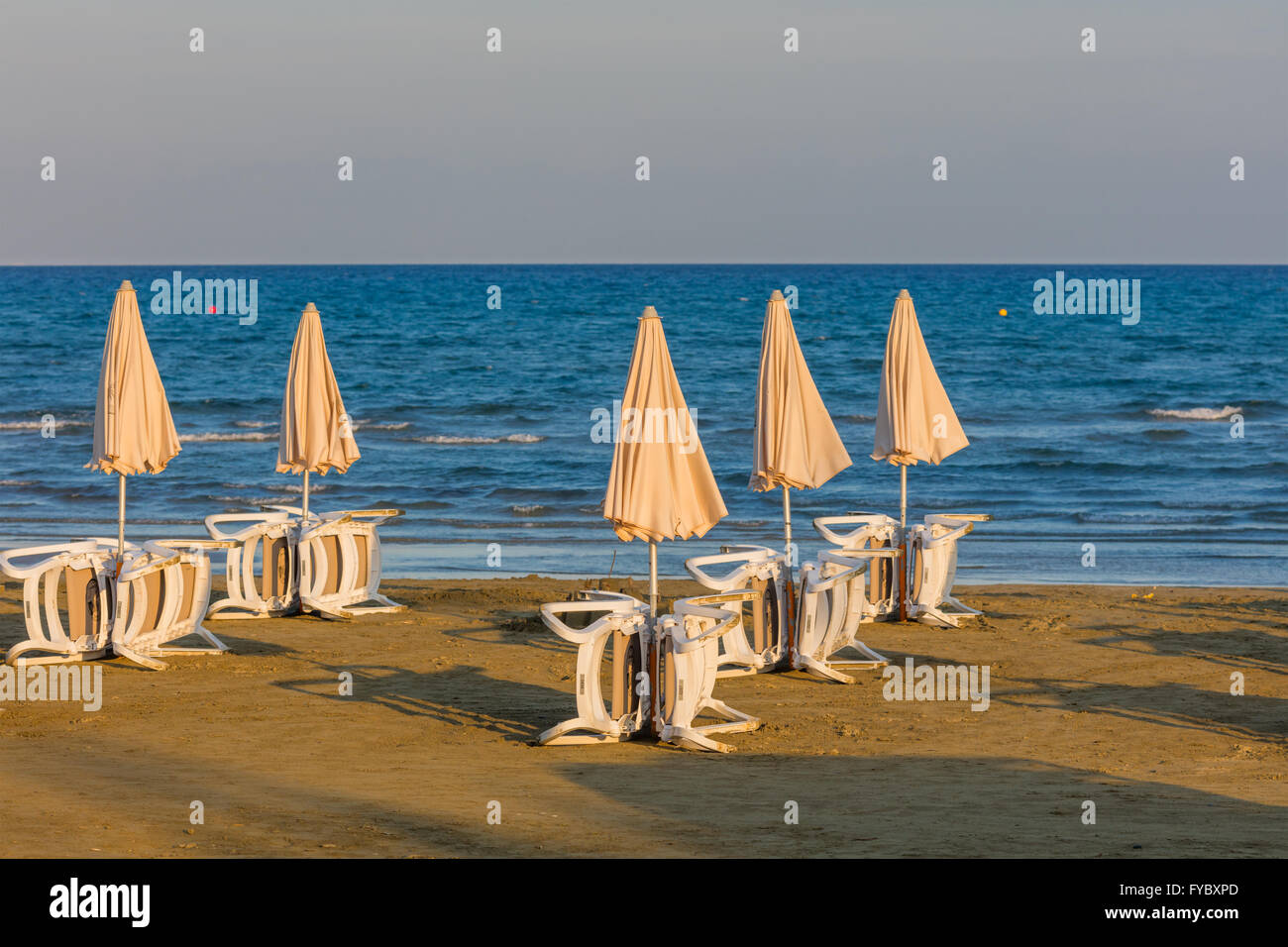 Mediterranean sea beach umbrellas on sand beach, Larnaca, Cyprus Stock ...