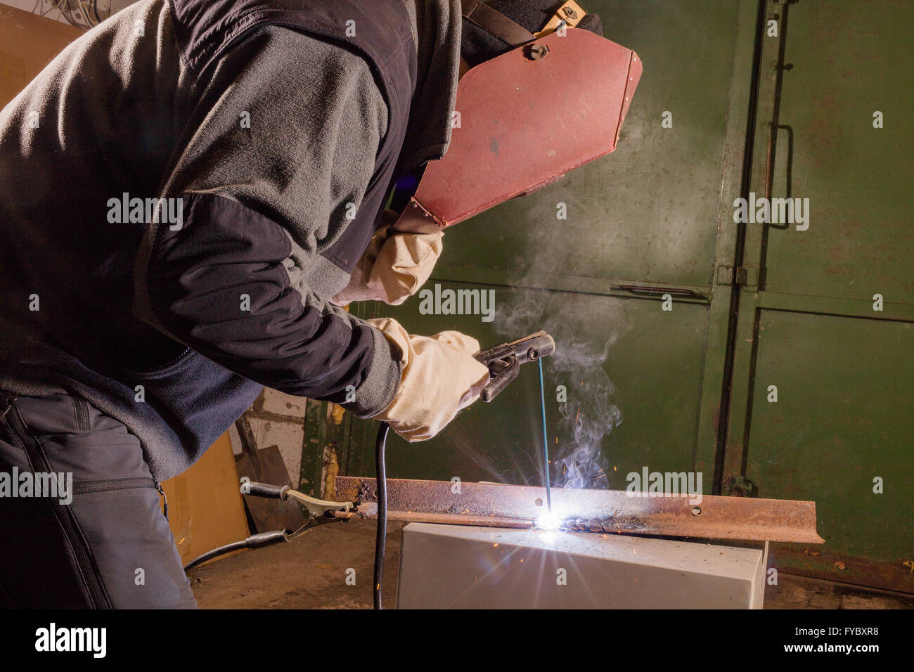 Welder working in a factory welding the metal Stock Photo - Alamy